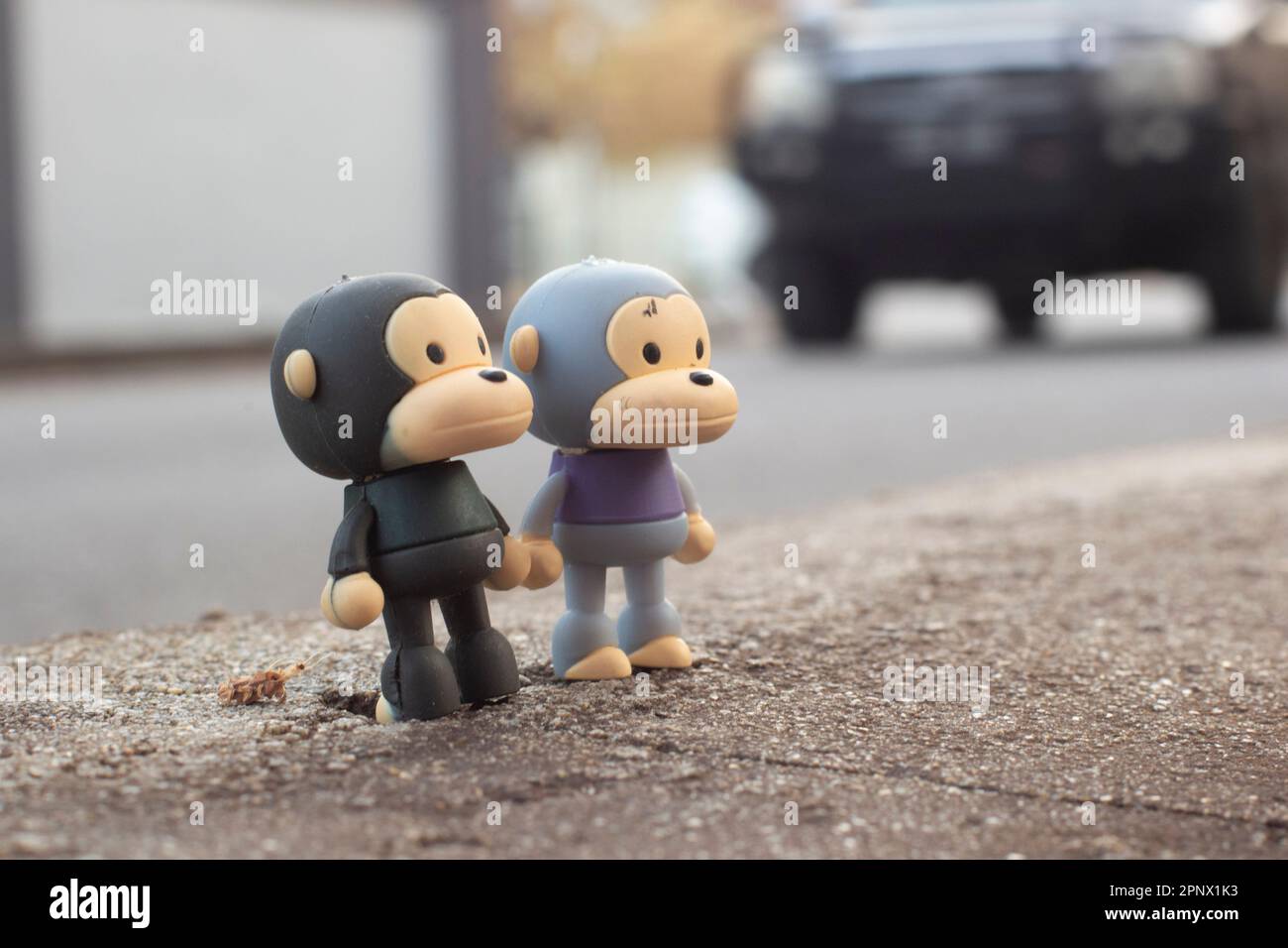 infrared image of the monkey toys on the asphalt street Stock Photo - Alamy