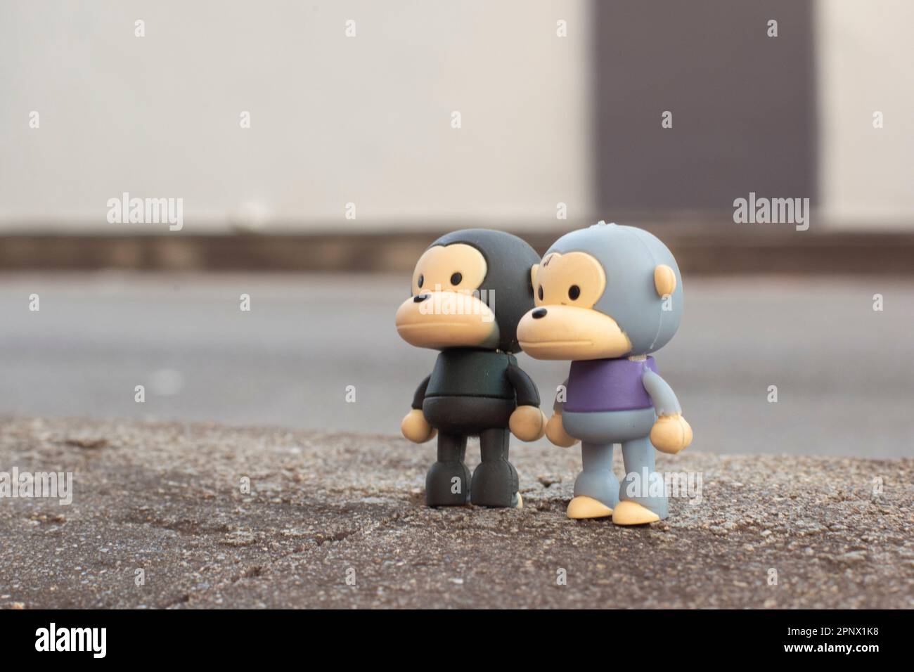infrared image of the monkey toys on the asphalt street Stock Photo - Alamy