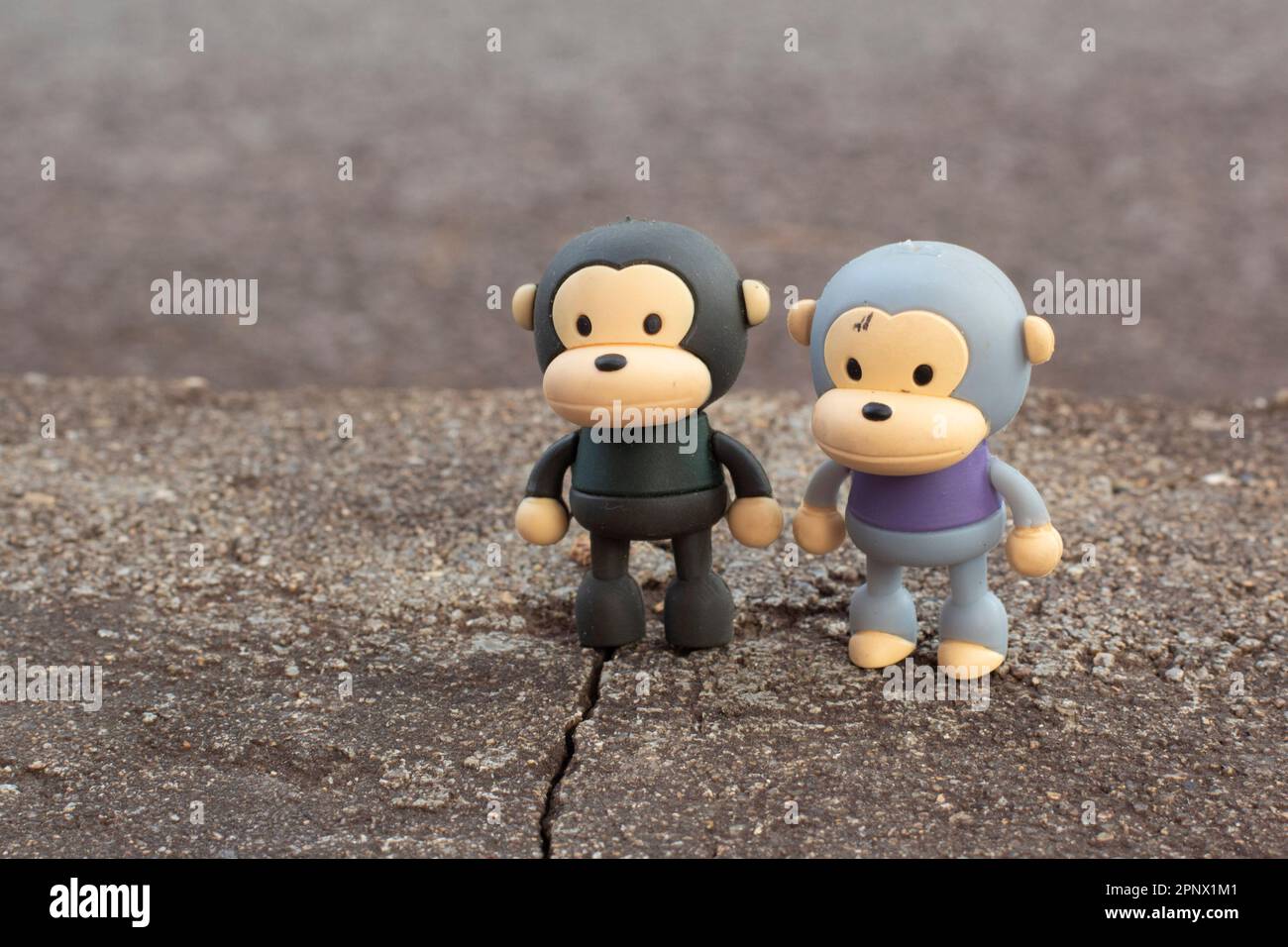 infrared image of the monkey toys on the asphalt street Stock Photo - Alamy