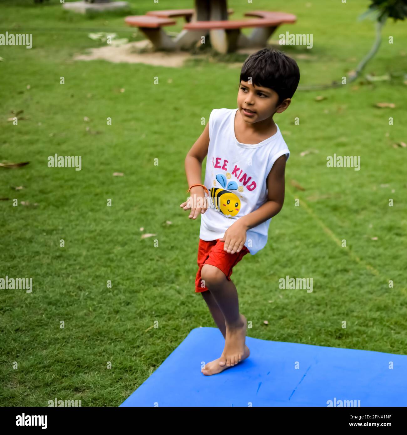Asian smart kid doing yoga pose in the society park outdoor, Children's ...