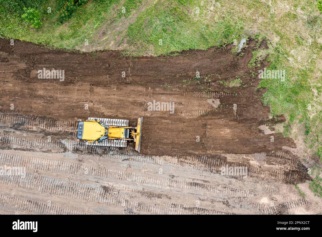 heavy construction machine is leveling the land. bulldozer is moving ...