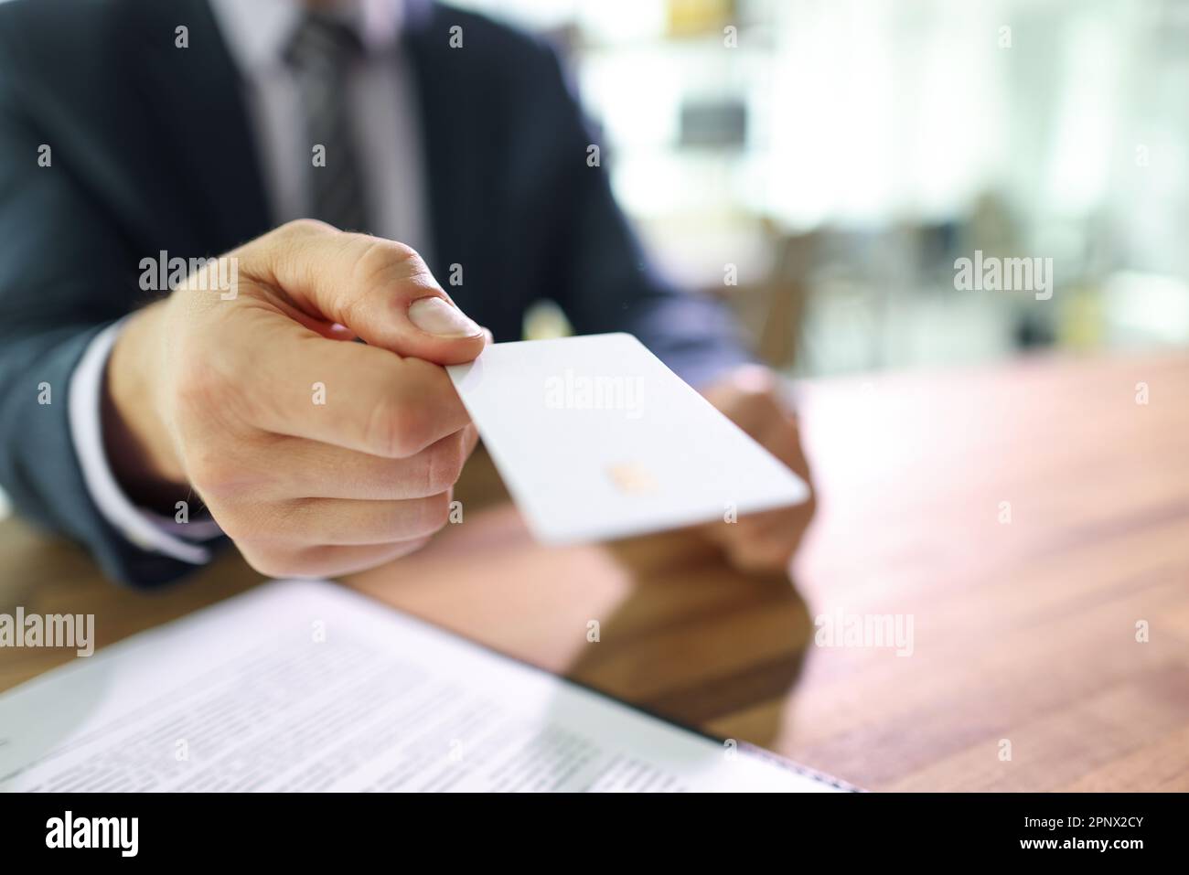 Successful businessman gives credit card to make e-payment Stock Photo ...
