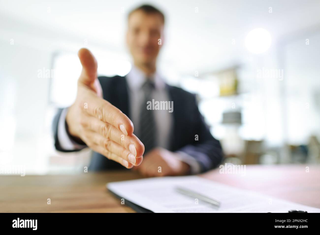 Office worker in business suit extends hand for handshake Stock Photo ...