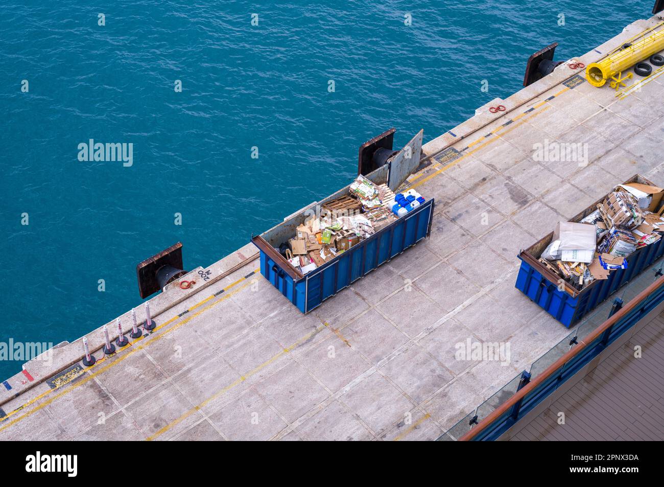 at the edge of the harbor are filled waste containers Stock Photo - Alamy