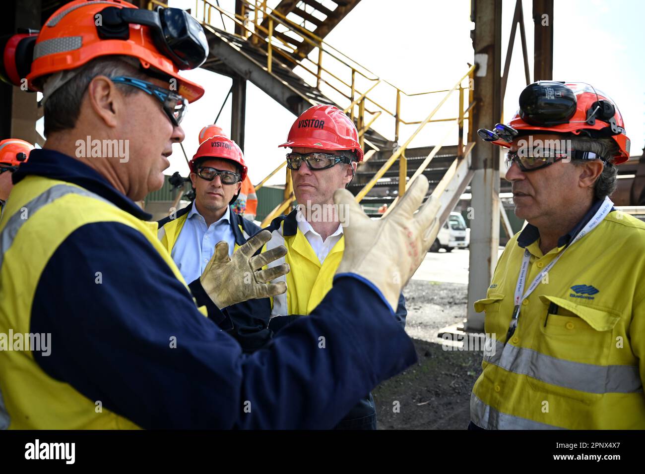 NSW Premier Chris Minns (centre) along with CEO Mark Vassella (left ...