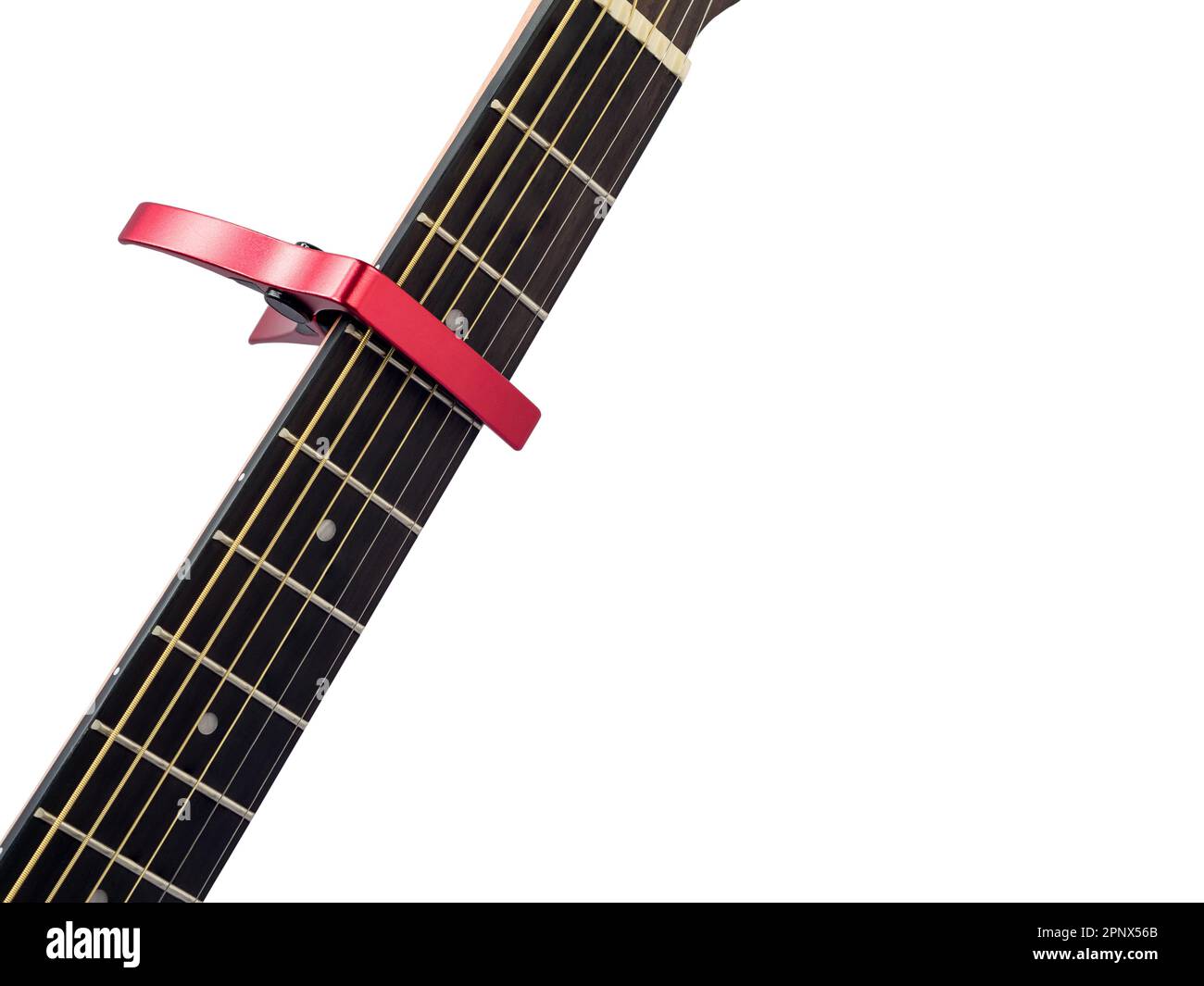 Red capo on guitar fingerboard, white background , close up Stock Photo ...
