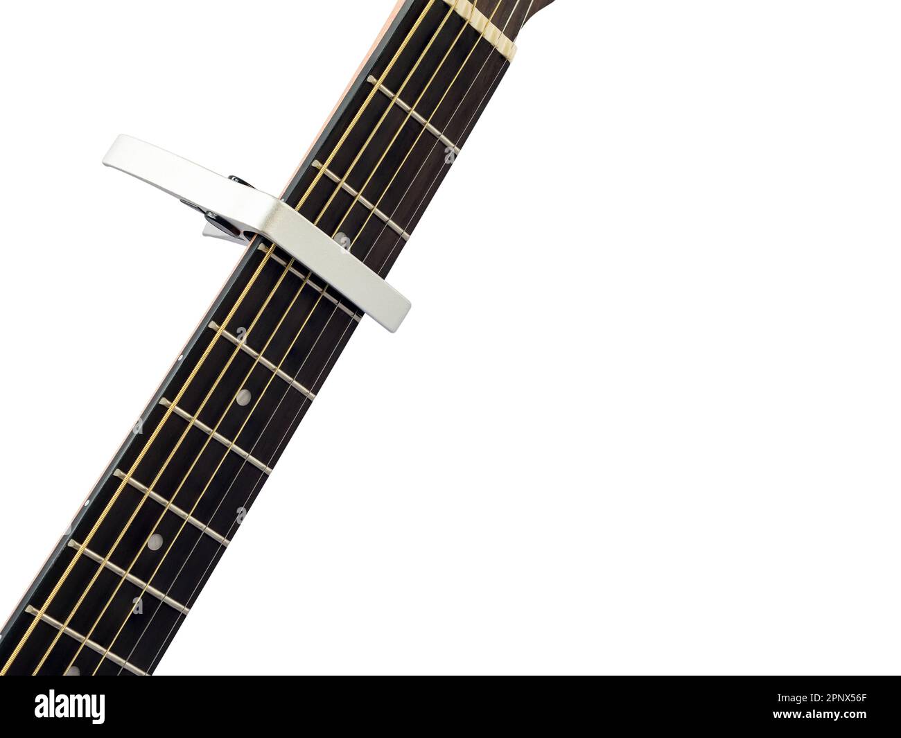 Silver capo on guitar fingerboard, white background , close up Stock ...