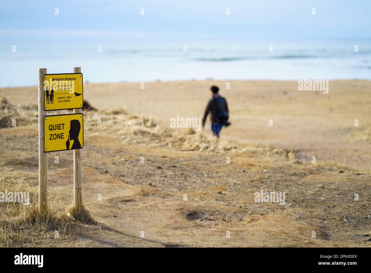 Yellow warning signs, Quiet Zone and Keep your distance posted at Ytri ...