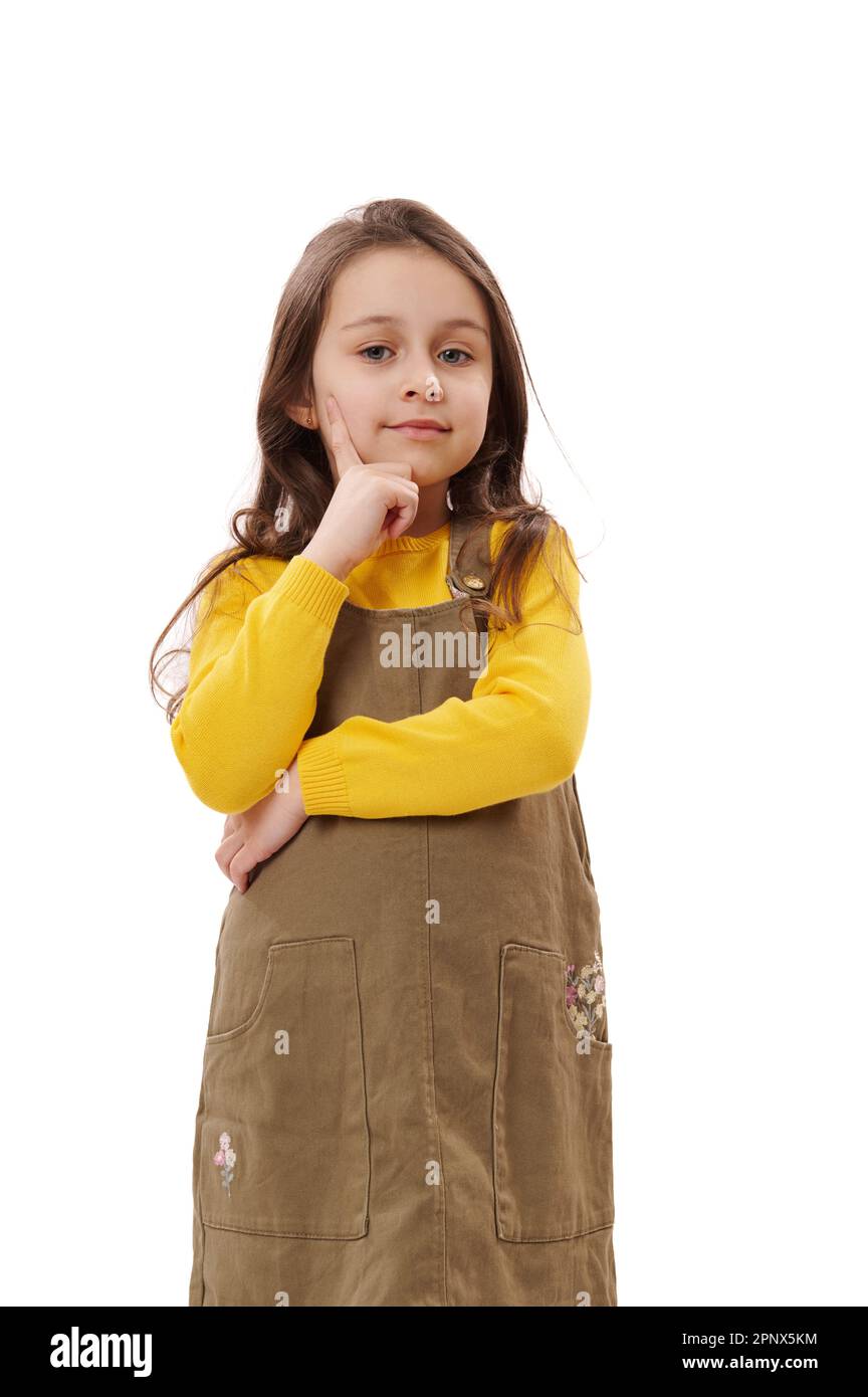 adorable kid girl holding finger on her chin and reasoning seriously ...