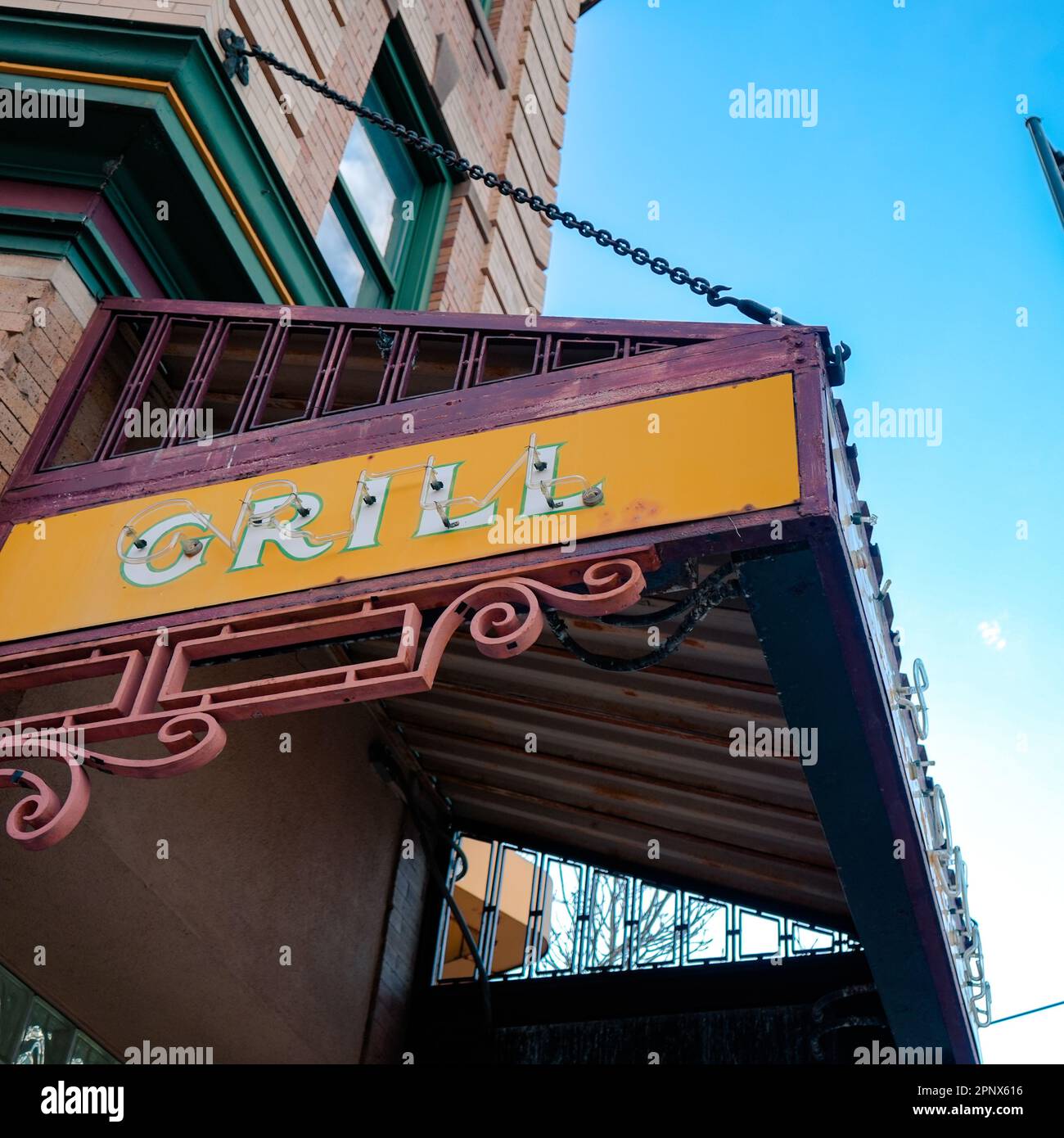 Grill restaurant neon sign in the day Stock Photo - Alamy