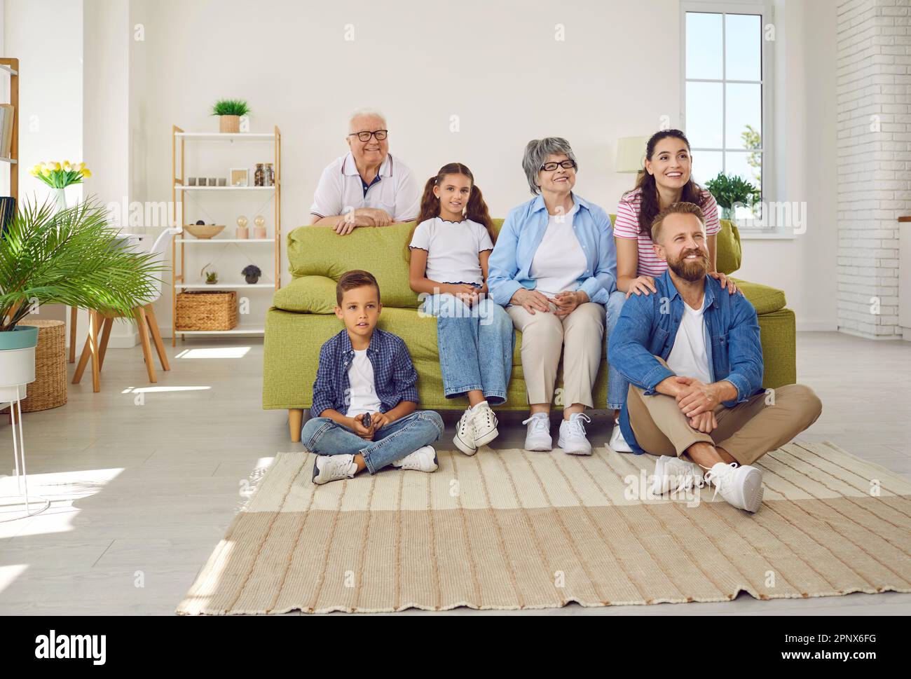 Three generations family watching tv hi-res stock photography and ...