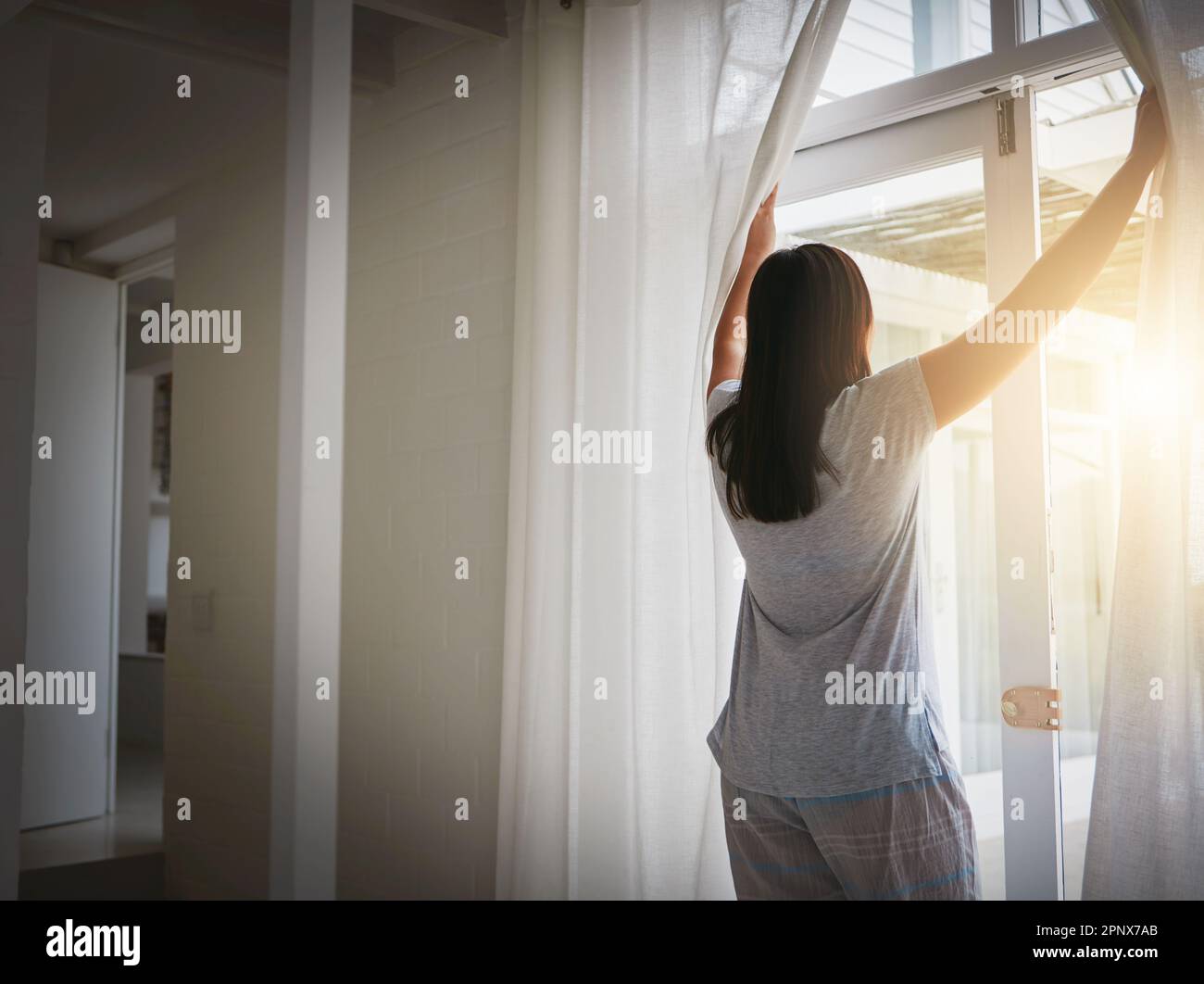 Woman opening curtains let hi-res stock photography and images - Alamy