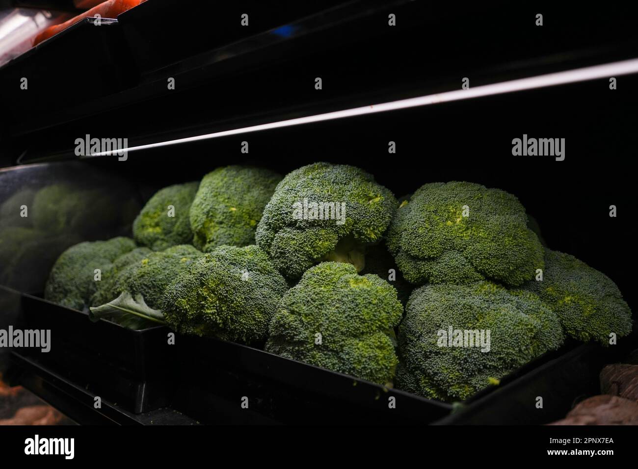 Broccoli crowns on the shelf in a store Stock Photo - Alamy