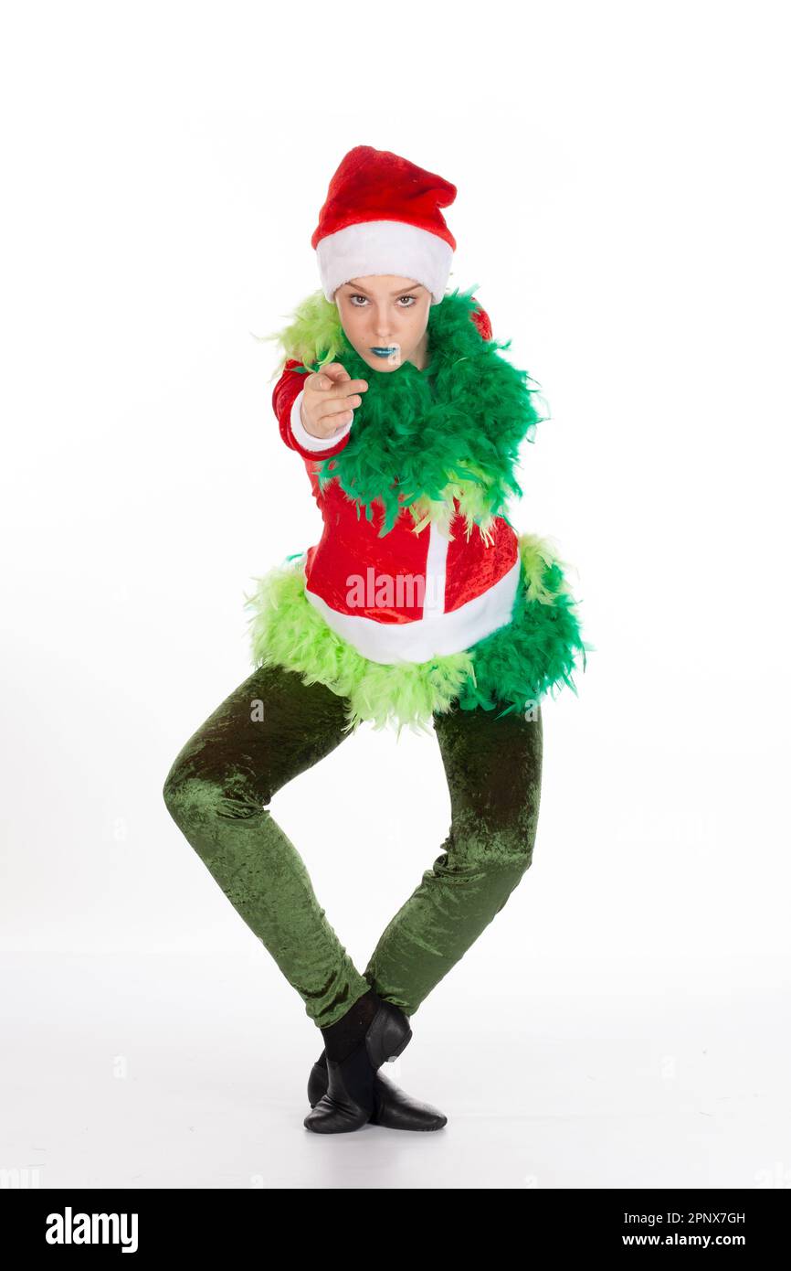 Young girl wearing red santa clause hat, Christmas grinch looking at ...