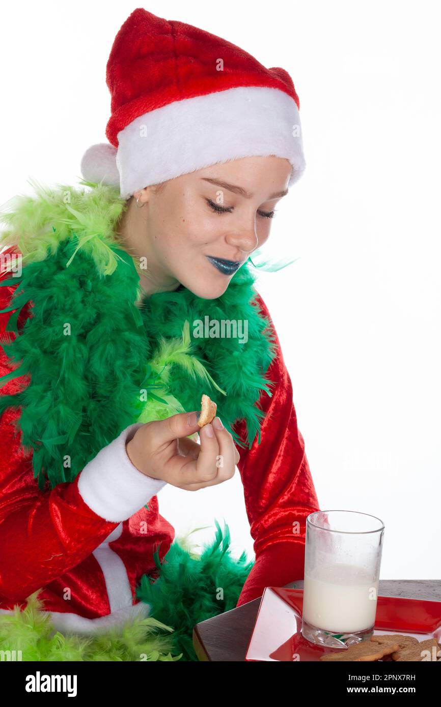 Closeup portrait of young girl wearing red santa clause hat like grinch ...