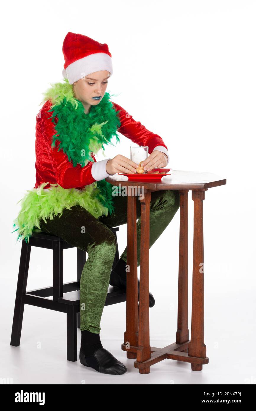 Full portrait of young girl wearing red santa clause hat like grinch ...