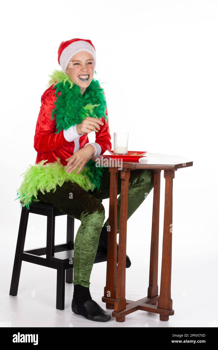 Full portrait of young girl wearing red santa clause hat like grinch ...