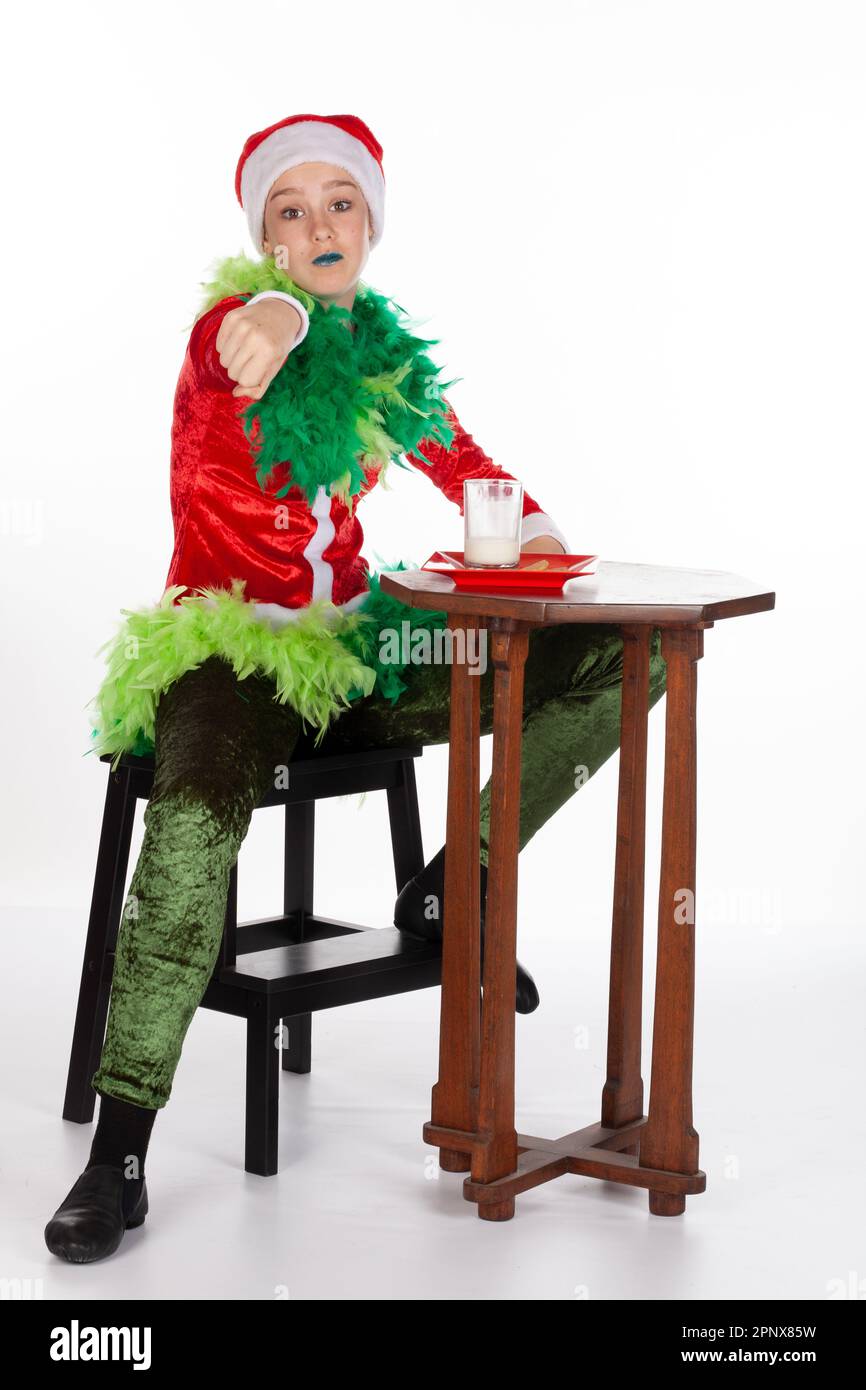 Full portrait of young girl wearing red santa clause hat like grinch ...