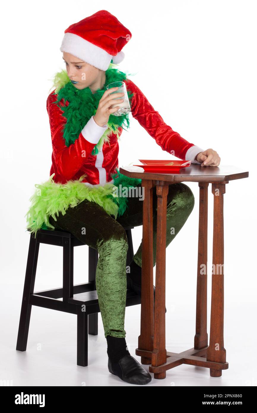 Full portrait of young girl wearing red santa clause hat like grinch ...