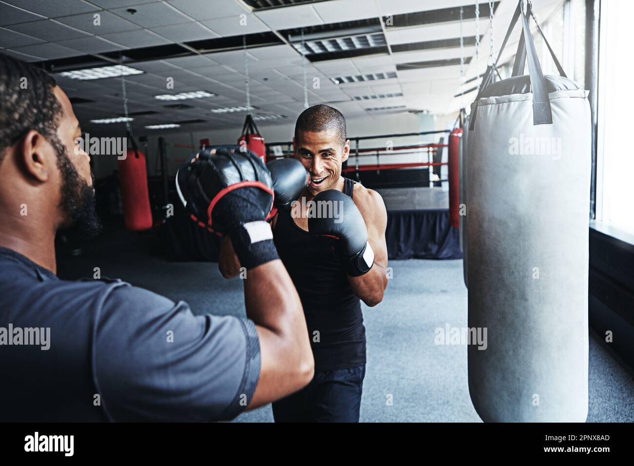 Theres a champion in all of us. a male boxer practising his moves with ...