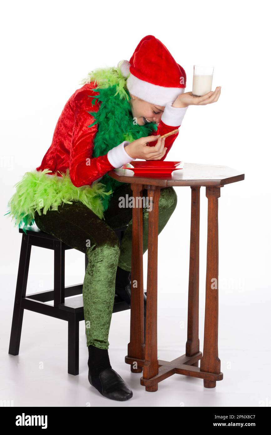 Full portrait of young girl wearing red santa clause hat like grinch ...