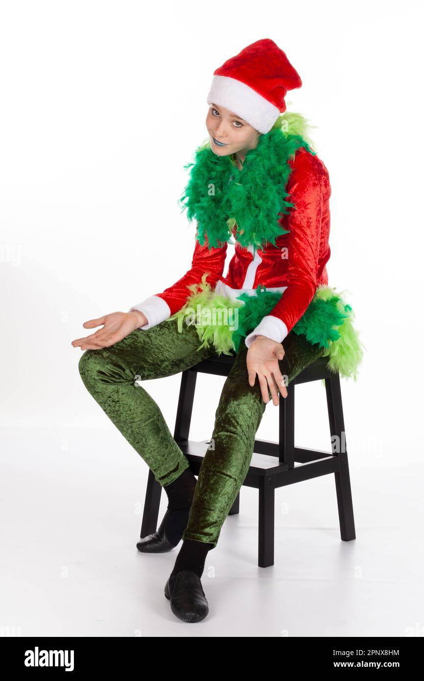 Young girl wearing red santa clause hat like a grinch with a 'come on ...