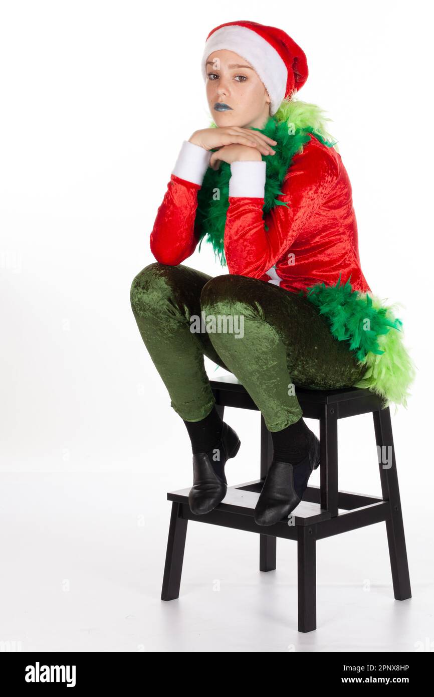 Sitting young girl wearing red santa clause hat like a grinch Grinch ...