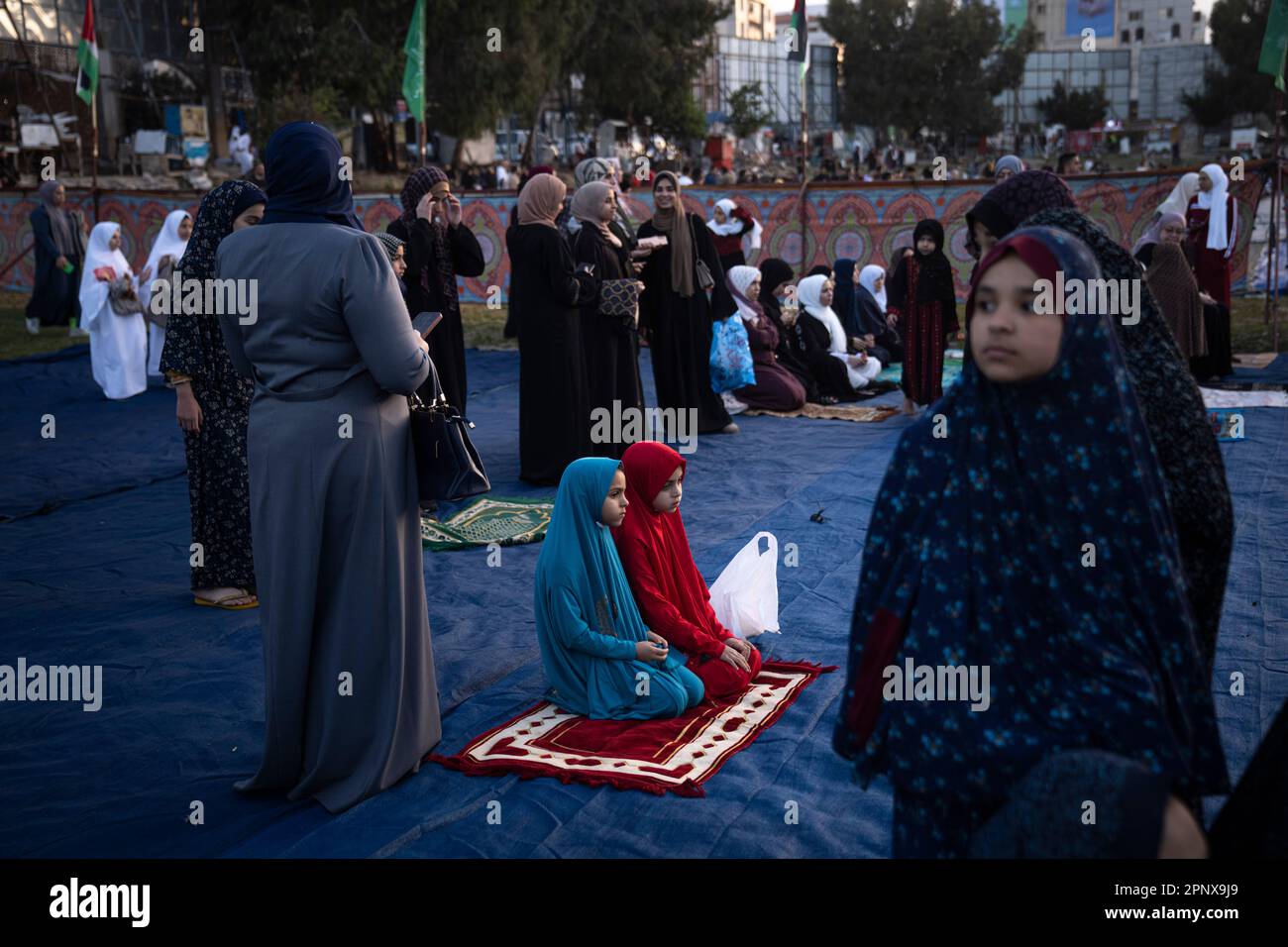 Palestinian Muslims attend Eid al-Fitr prayers, marking the end of the ...
