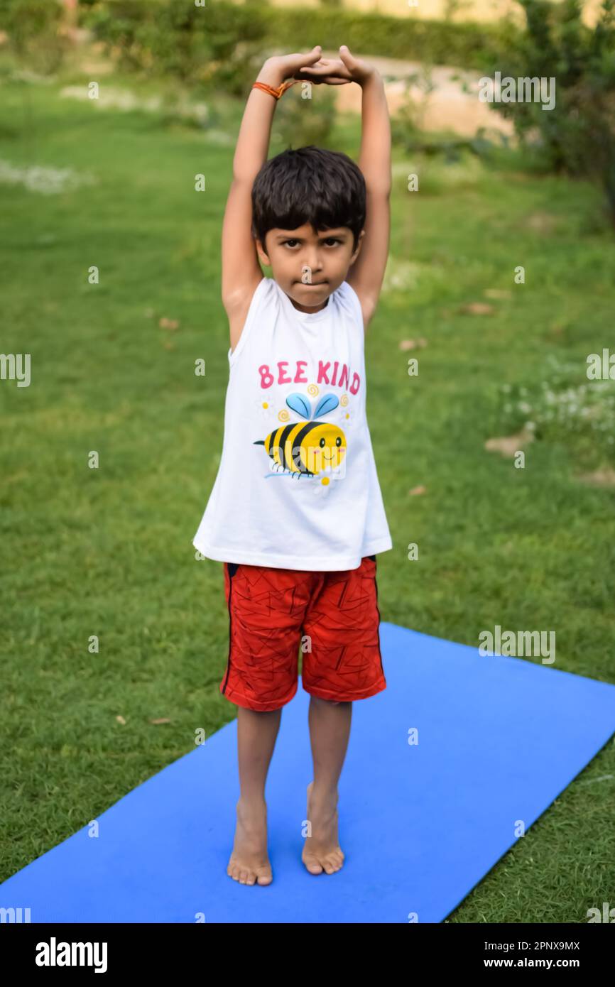 Asian smart kid doing yoga pose in the society park outdoor, Children's ...