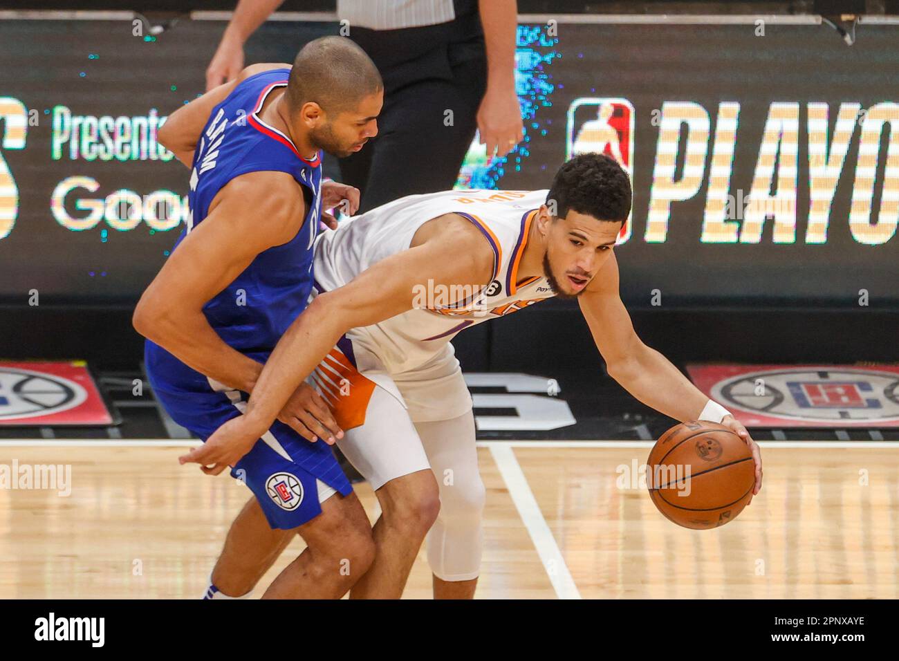Los Angeles, California, USA. 20th Apr, 2023. Phoenix Suns guard Devin Booker (1) is defended by ...