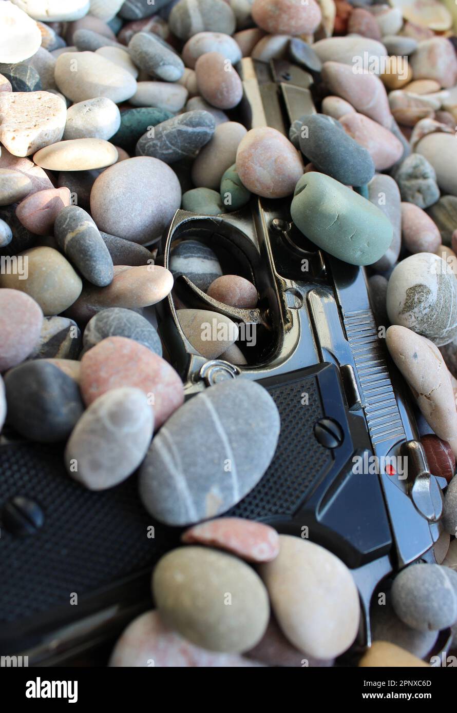 Handgun Half Covered With Smooth Stones Detailed Stock Photo For ...