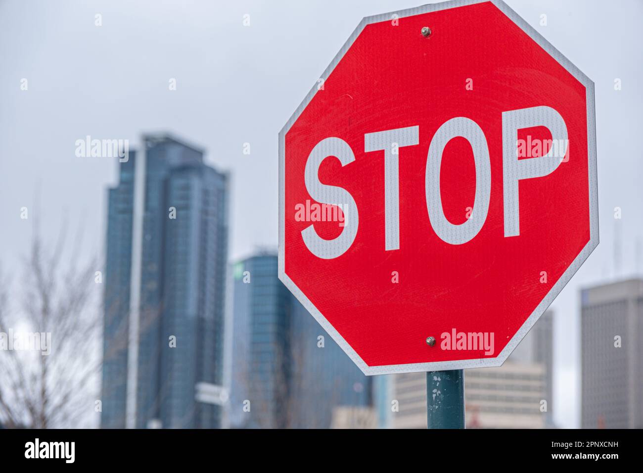 Stop sign with winnipeg Manitoba skyline in background Stock Photo - Alamy