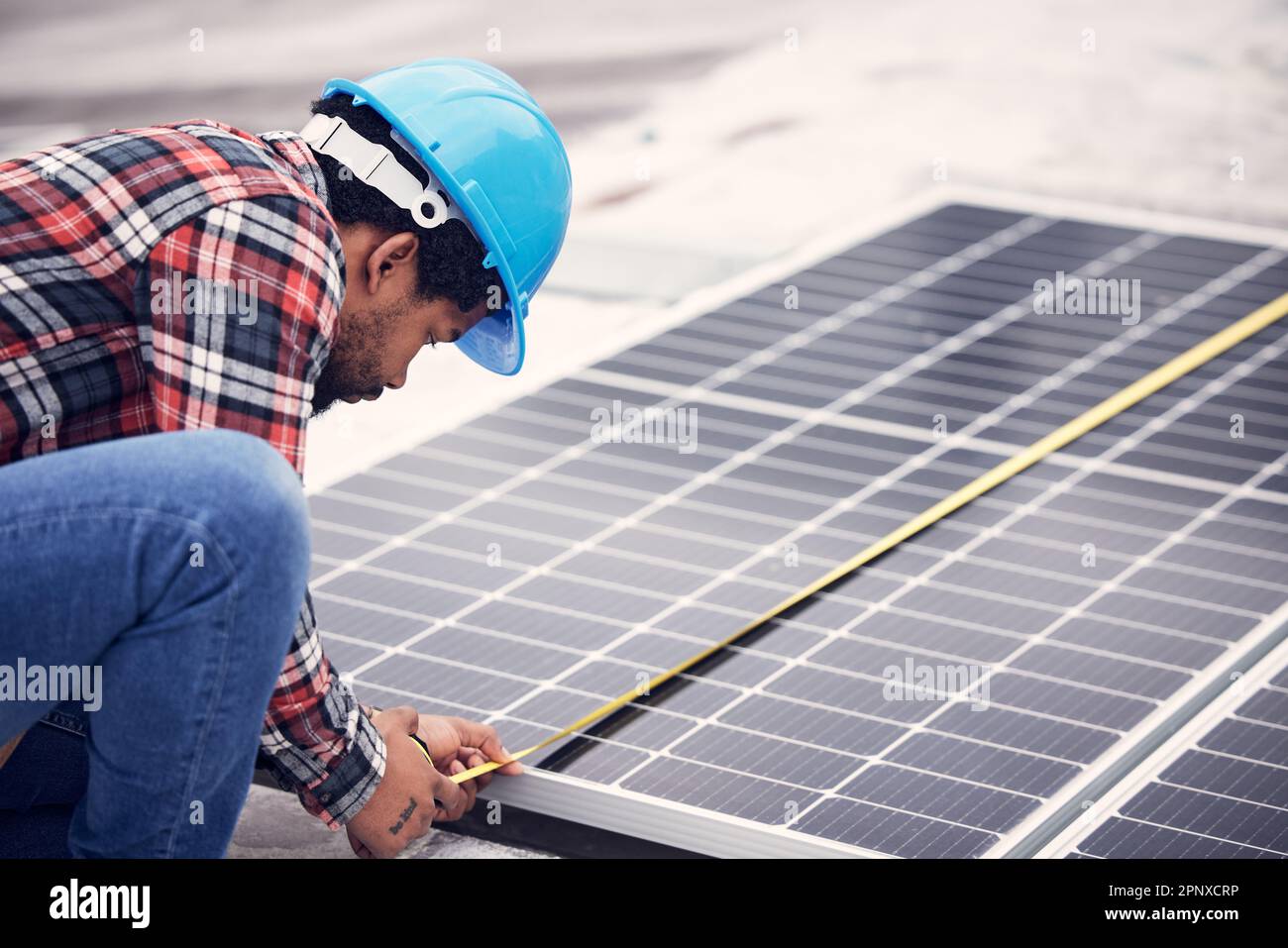 Technician, measuring tape and solar panel on rooftop for check ...