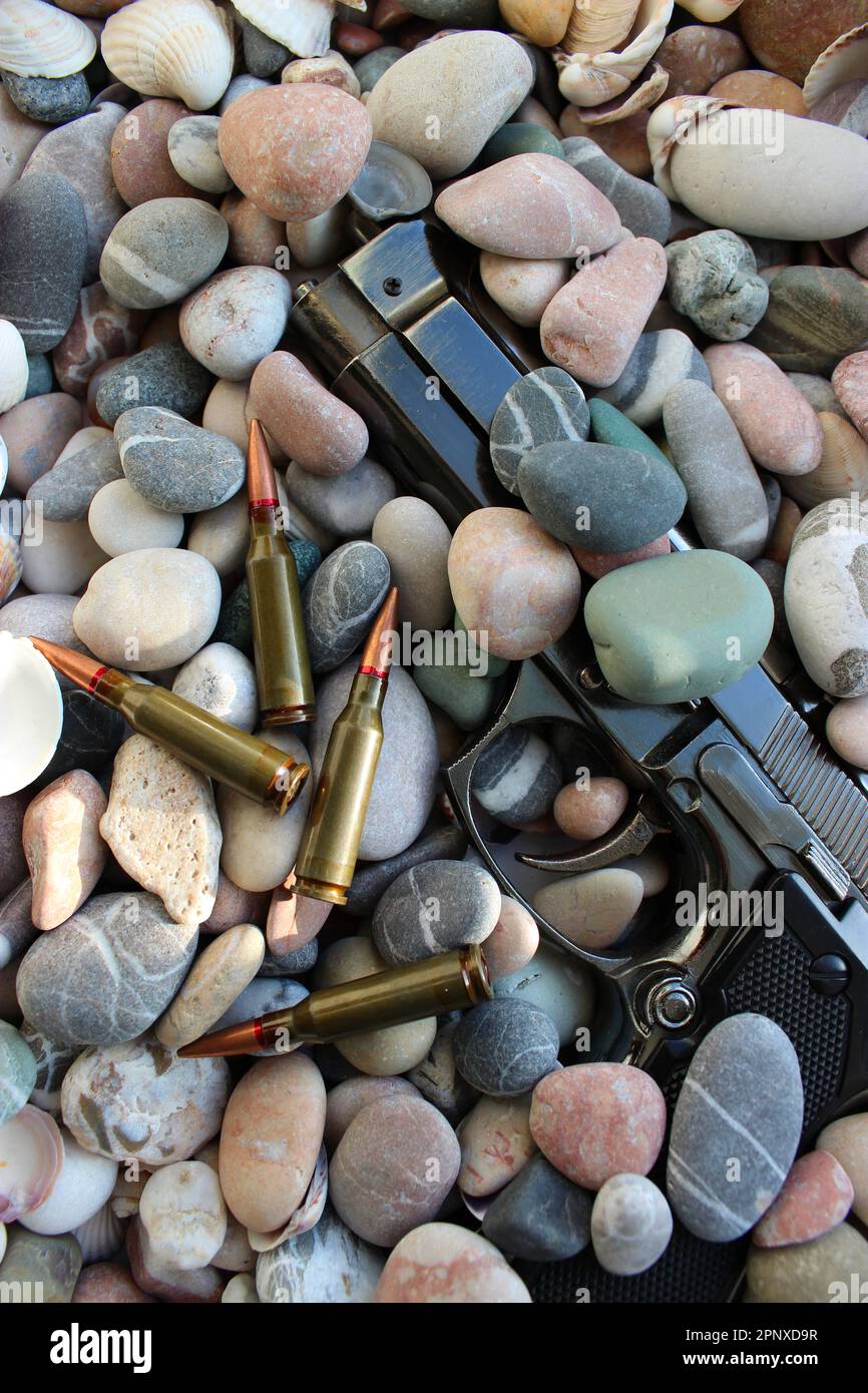 Bullets Near Discarded Handgun In A Small Pebbles On Sea Shore Stock ...