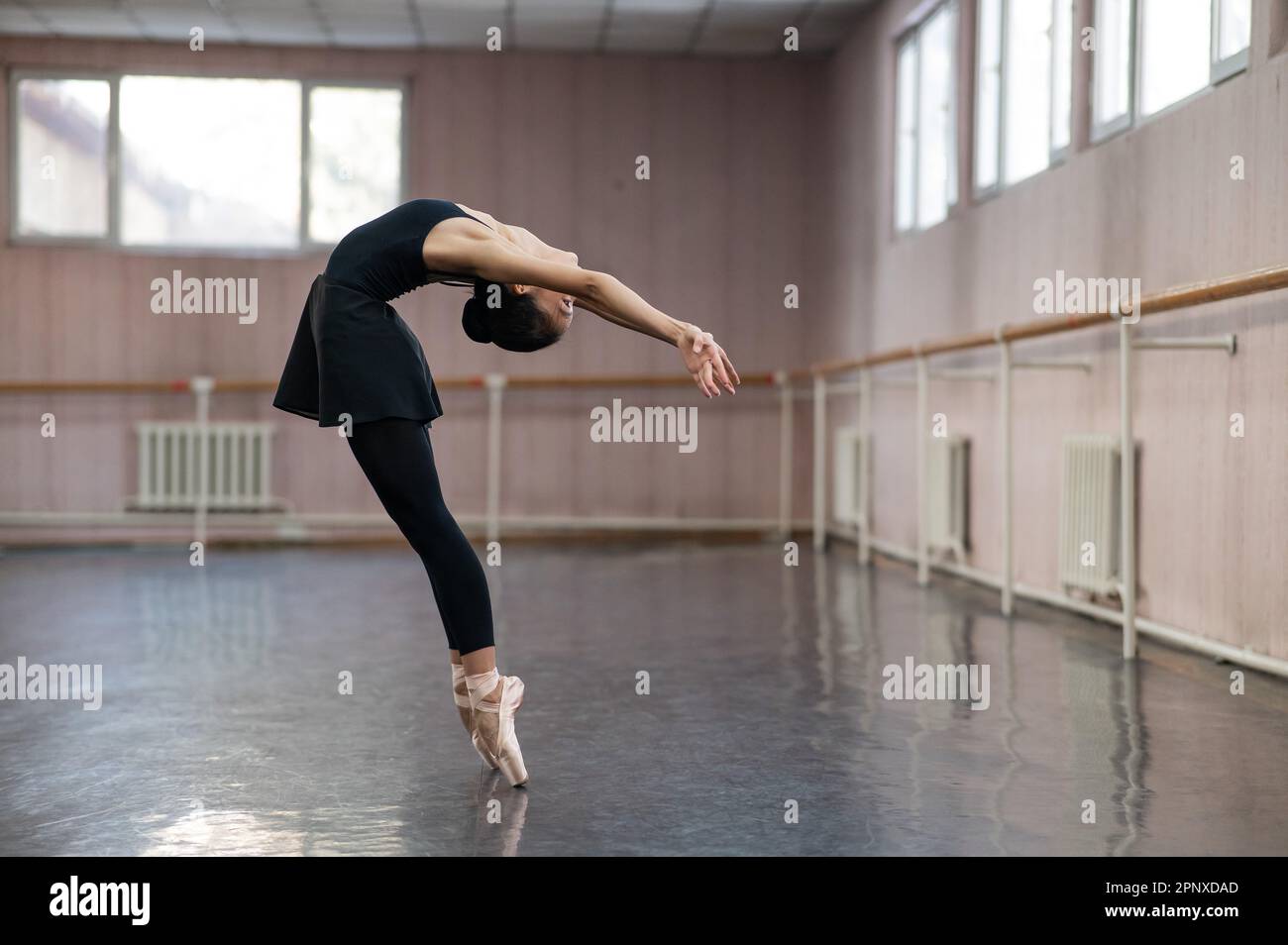 Asian woman dancing in ballet class. Bending in the back Stock Photo ...