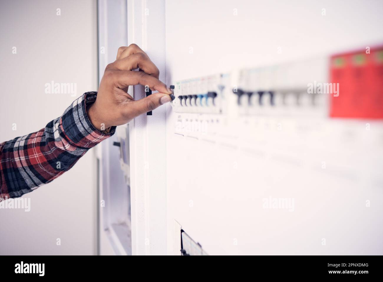 Man, hand and electrician with electricity fuse box, check power supply ...