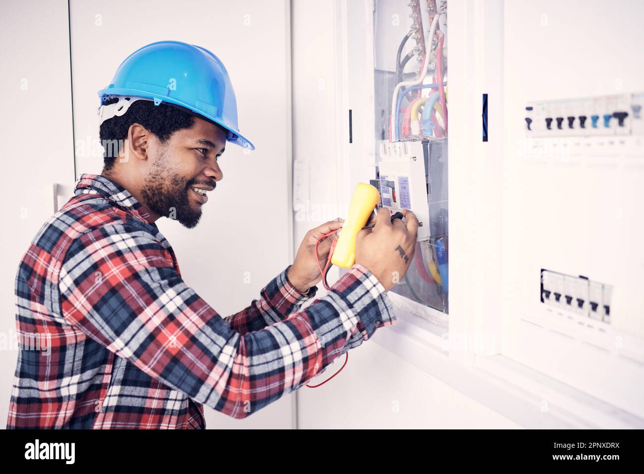 Electrician multimeter, electric switch box and happy man check cable ...