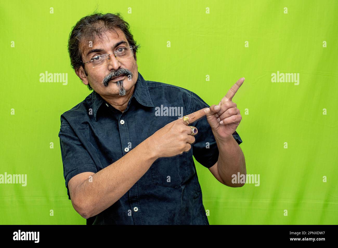 A smart businessman in black shirt and spectacle shows the left ...