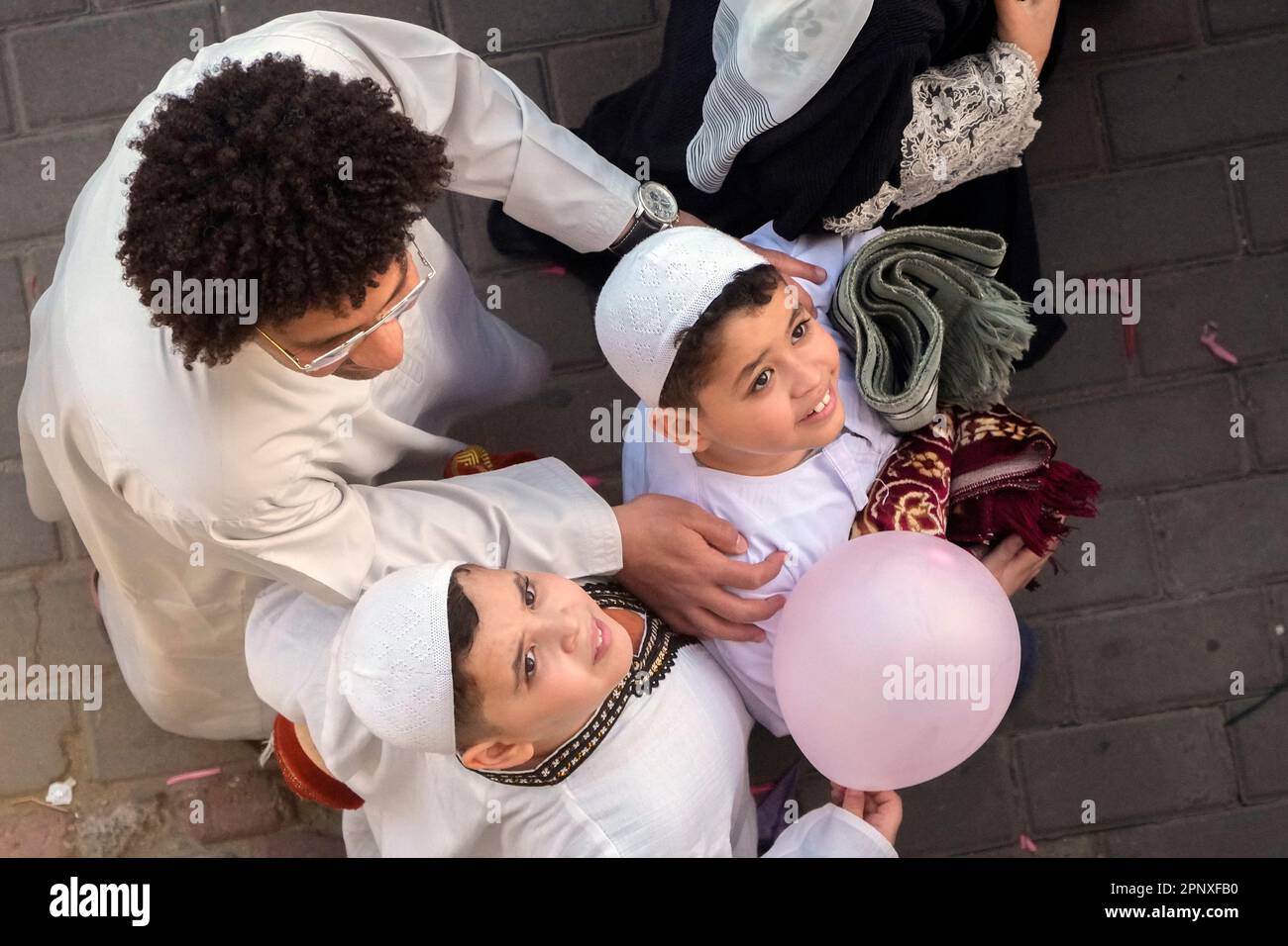 Egyptian Muslims hold a balloon distributed for free after Eid al-Fitr ...
