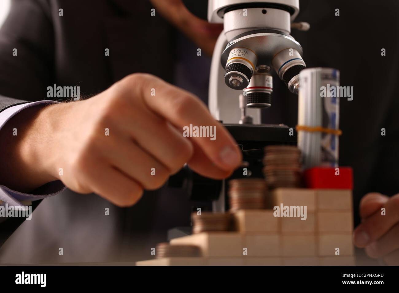 Hand microscope coin hi-res stock photography and images - Alamy