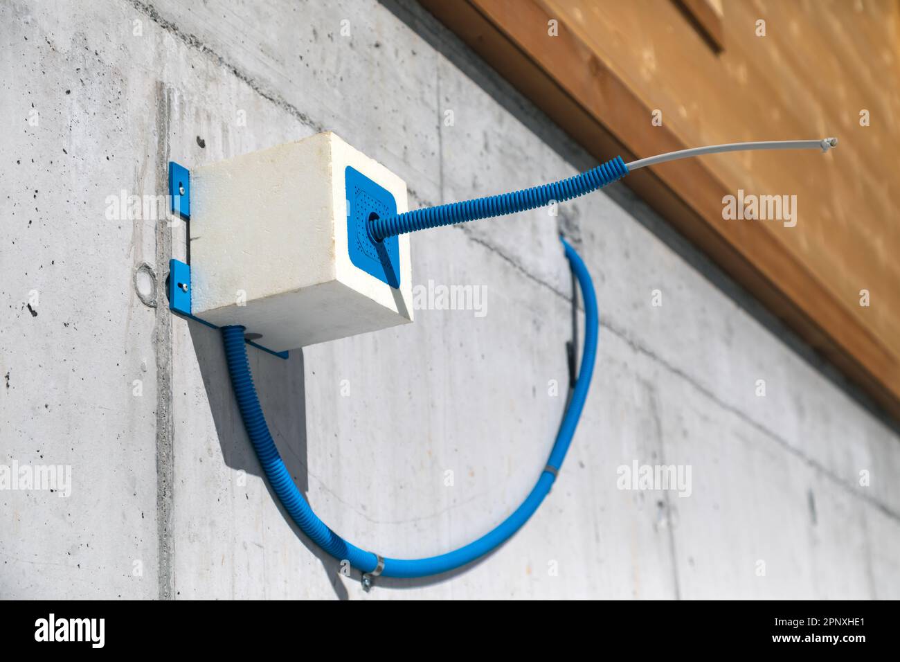 electrical socket holder on a concrete wall Stock Photo - Alamy