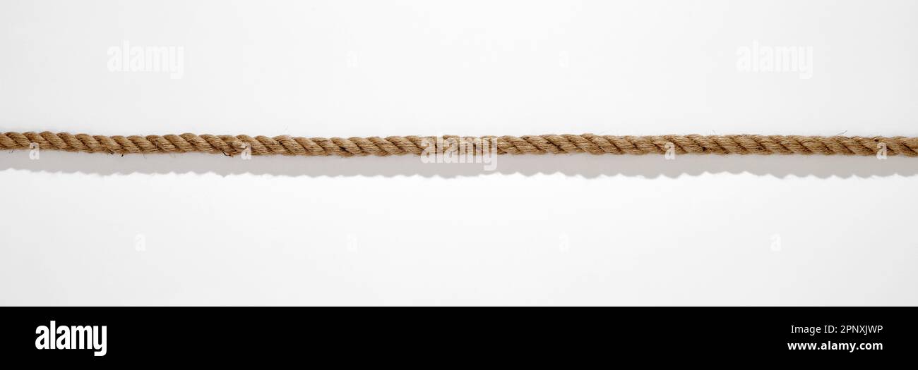 Top view of long straight rope with shadow placed on white background ...