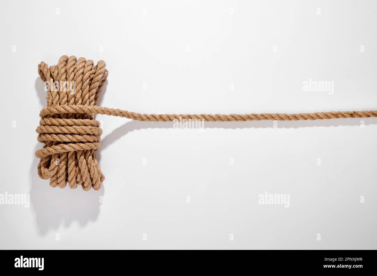 Top view of tied rope placed on white background with shadow in light ...