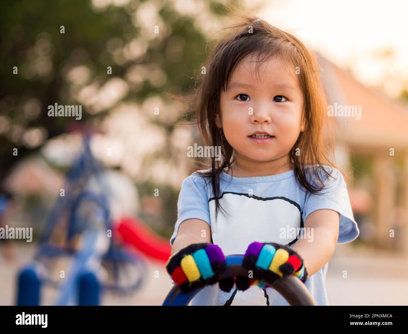 happy Asian child on a seesaw in sunset light Stock Photo - Alamy