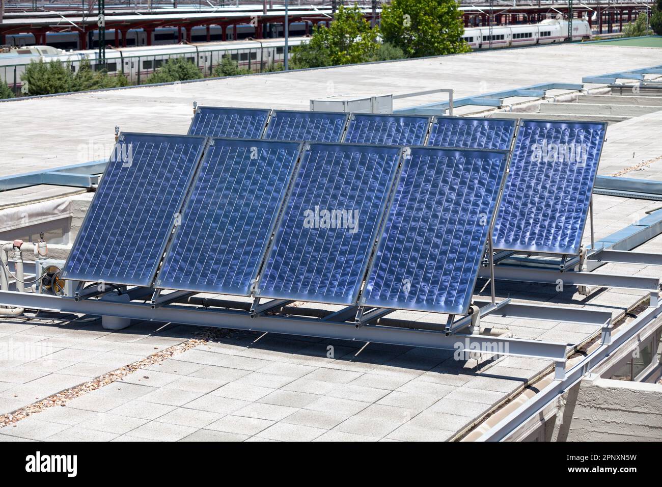 Solar panels on the top of a building roof in Madrid Stock Photo - Alamy