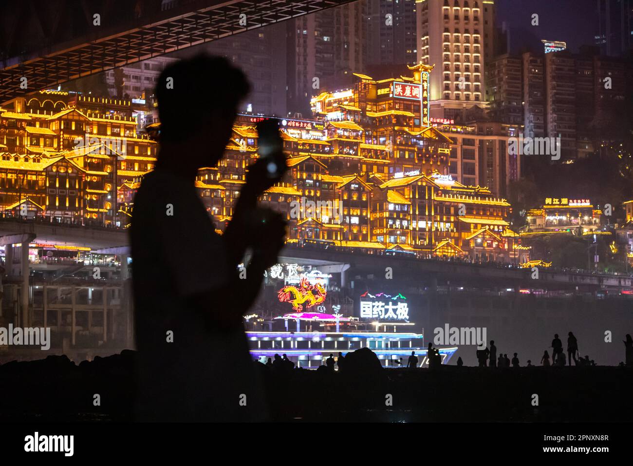 Tourists enjoy night view of the Hongyadong Scenic Spot in Chongqing ...