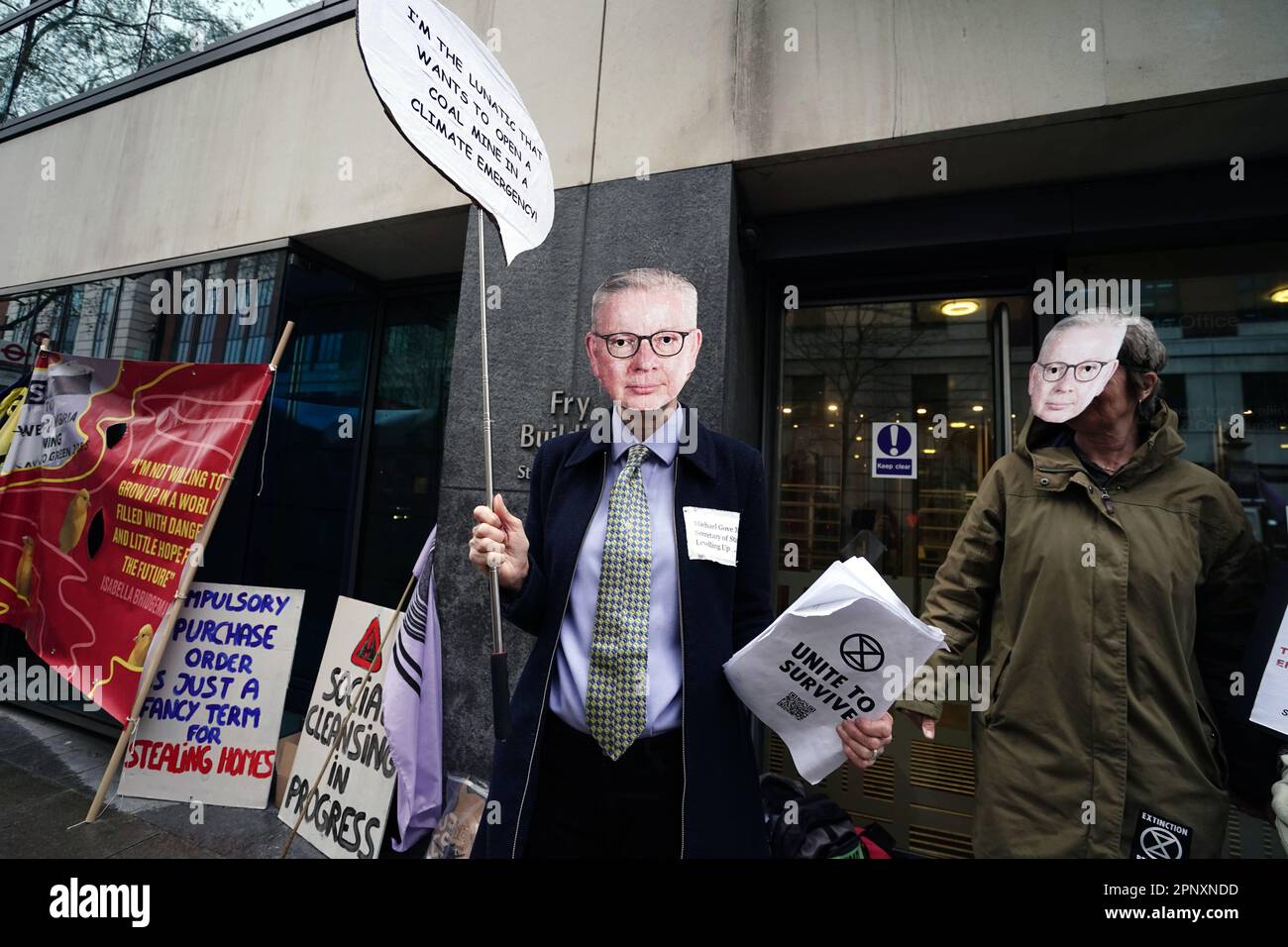 Extinction Rebellion demonstrators wearing Michael Gove face masks take ...