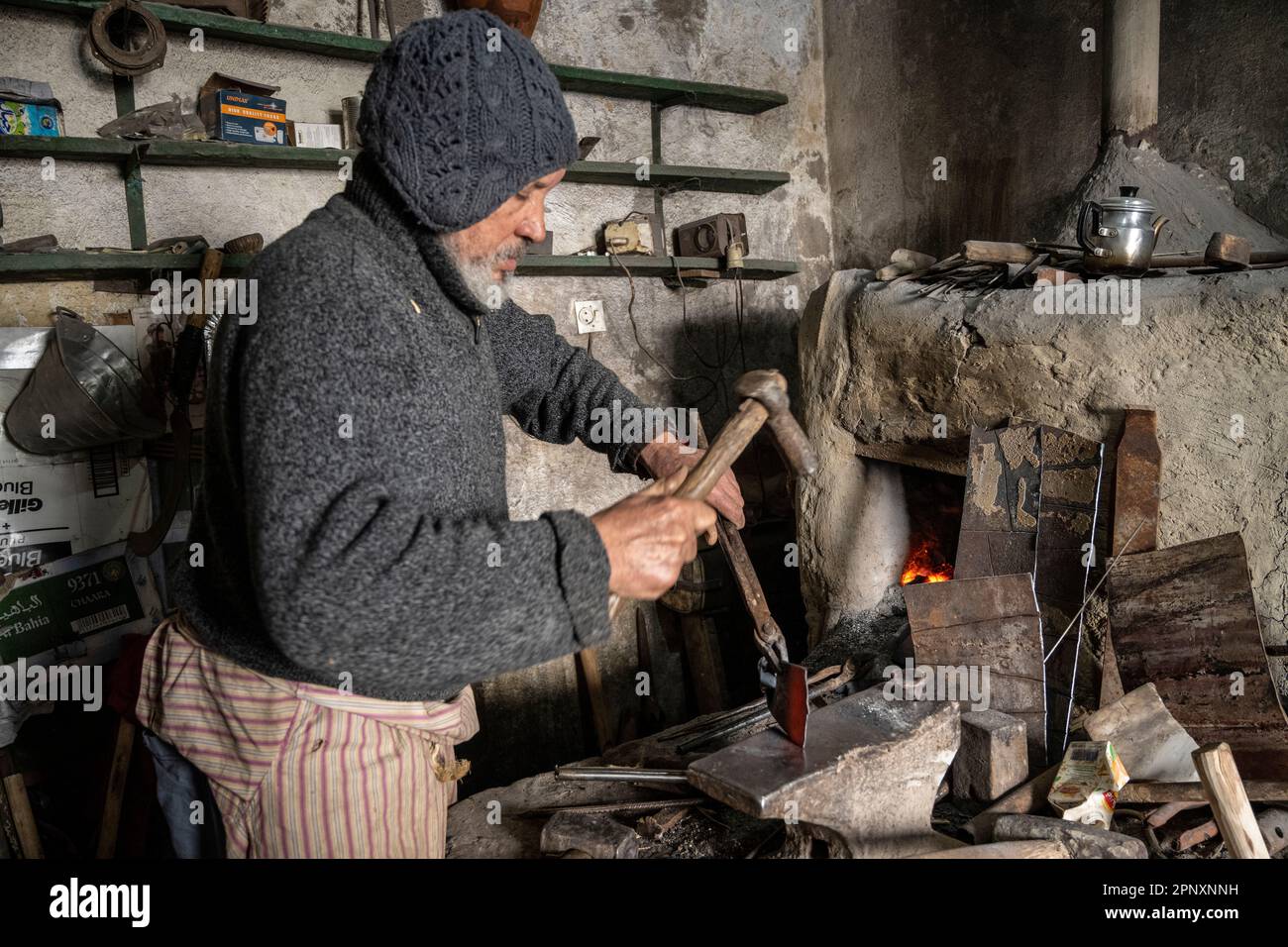 Traditional blacksmith working in the forge of his workshop Stock Photo ...