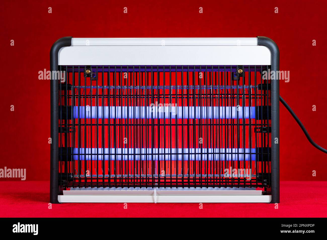 electric indoor mosquito and insect killer on red Stock Photo - Alamy