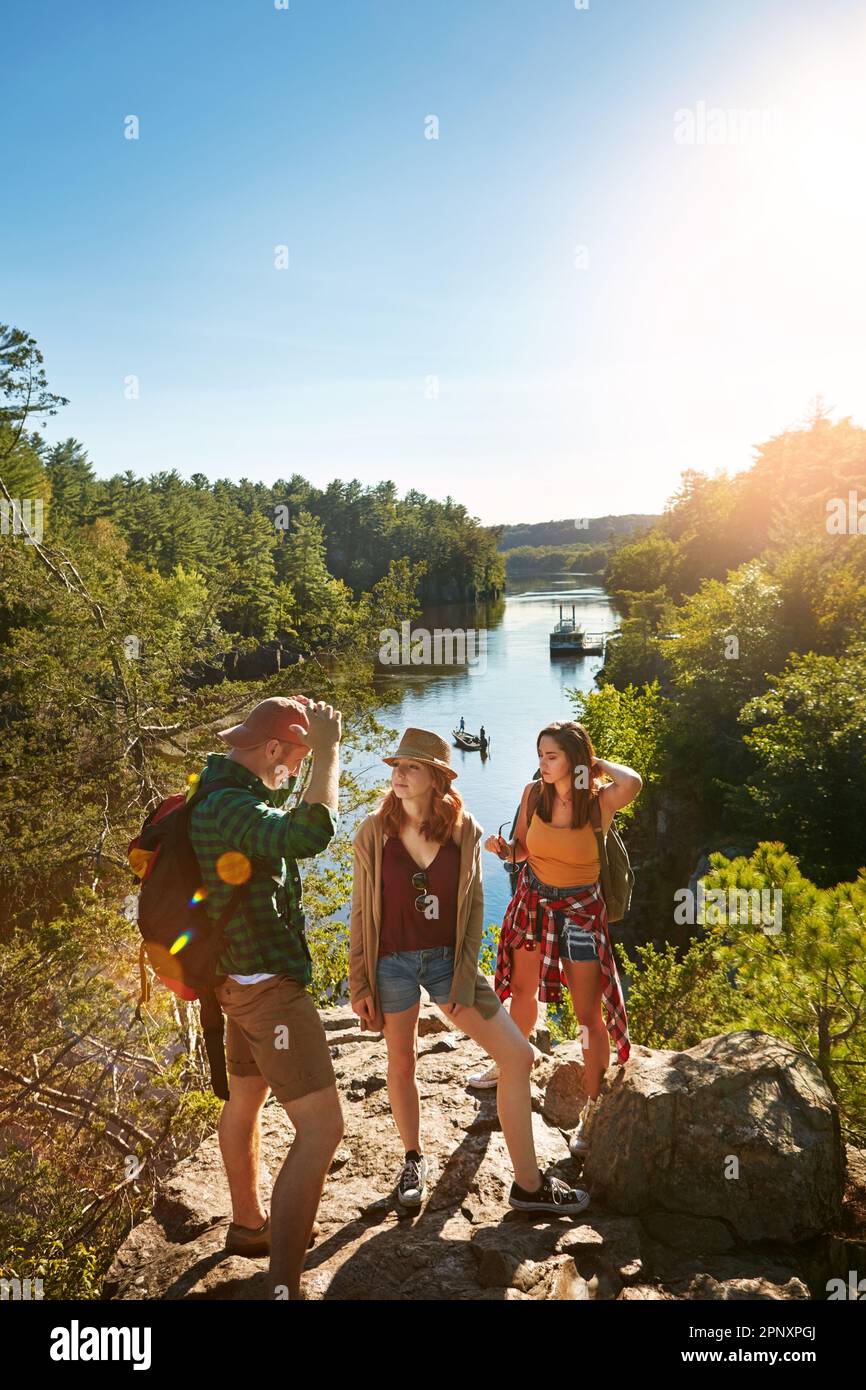 We prefer being out in nature. three friends out hiking in the ...